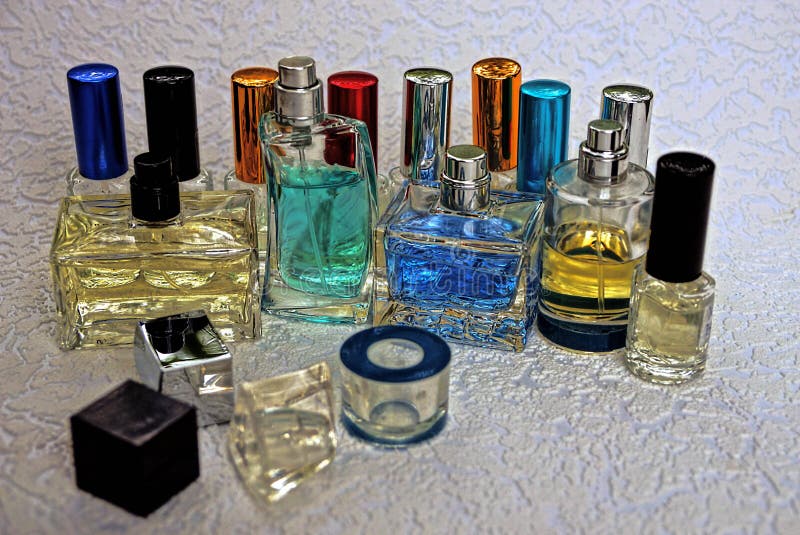 A Set of Glass Colored Bottles with Perfume on a Gray Surface Stock ...
