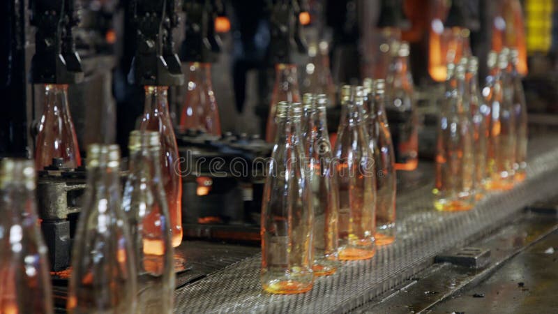 Glass Bottles Production. Glowing Red Hot Glass Bottles in a Production ...