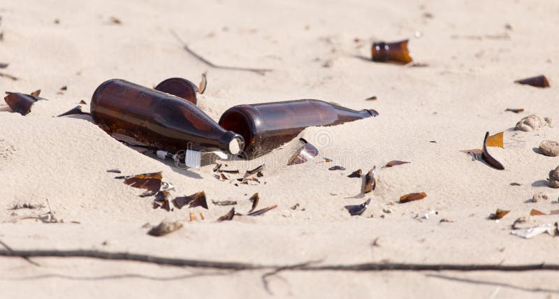 Glass Bottles in the Sand on Nature. Trash Stock Photo - Image of ...