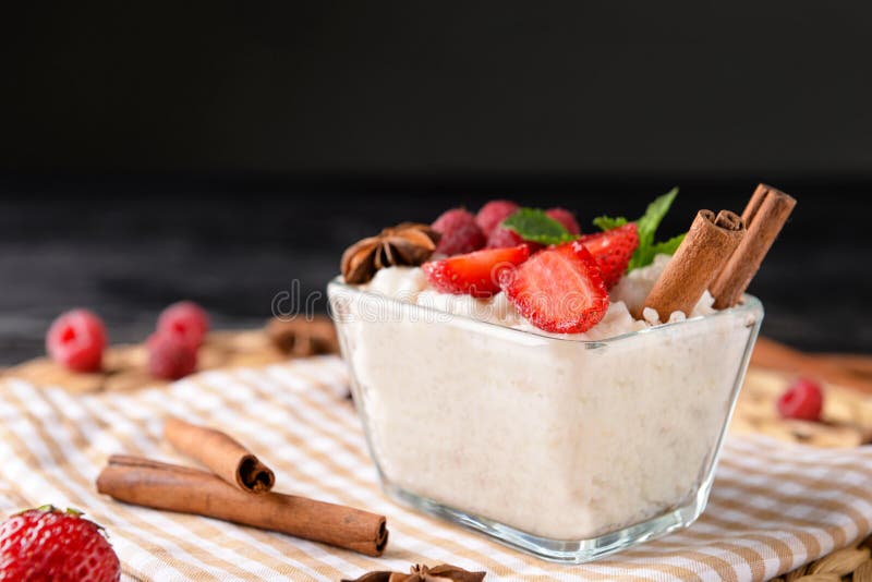 Glass Bowl with Delicious Rice Pudding and Berries on Napkin Stock ...