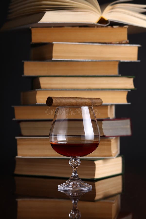 Glass of brandy and books stock image. Image of book - 42057491