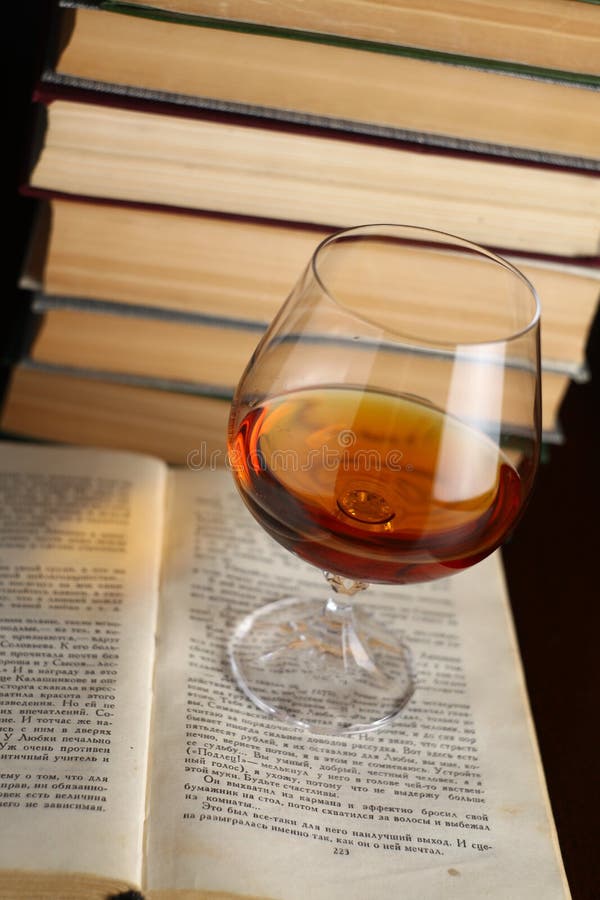 Glass of brandy on books stock image. Image of vintage - 42057517