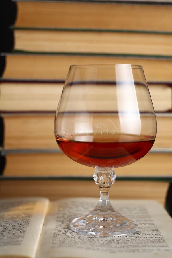 Glass of brandy on books stock image. Image of book, style - 42057519