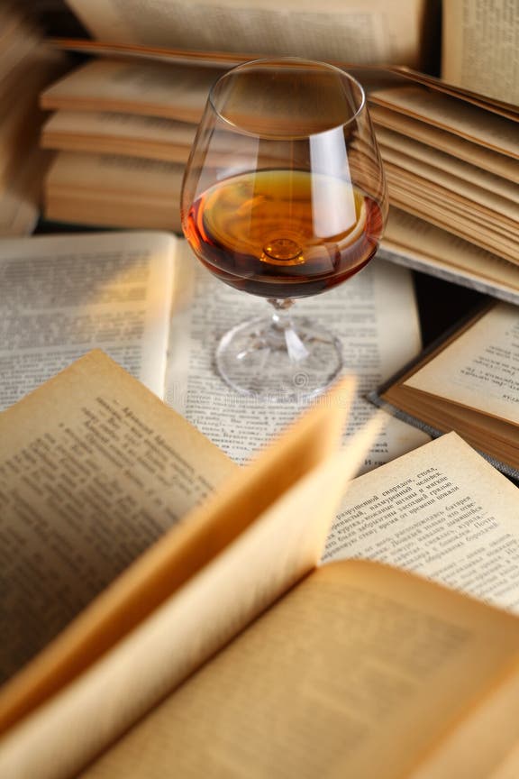 Glass of brandy on books stock photo. Image of dark, snifter - 42057526