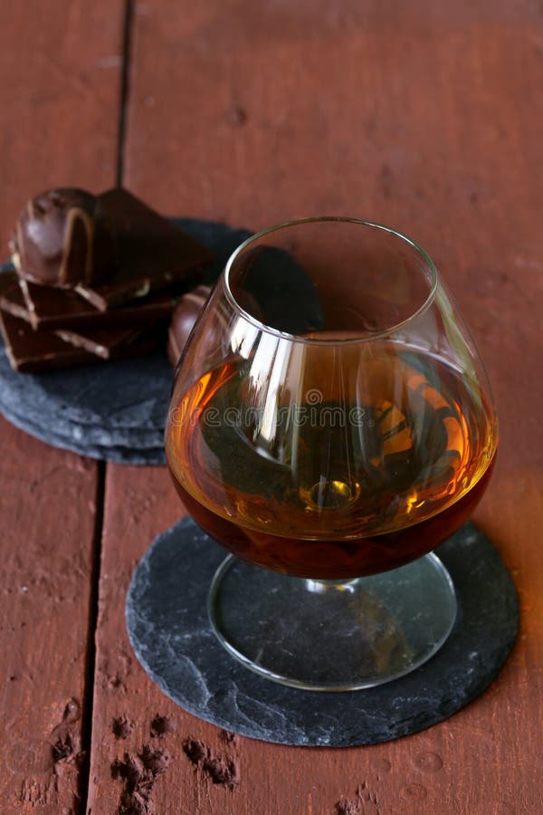 Glass of Brandy with Chocolate Stock Photo - Image of wooden ...