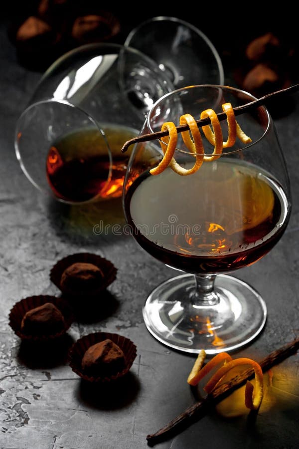 Glass of Brandy or Cognac and Chocolate Candy on Dark Table Stock Photo ...