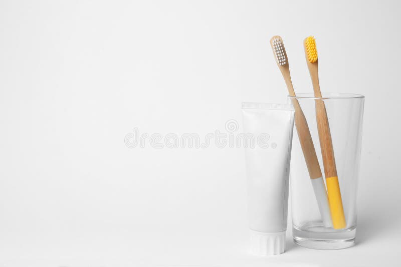 Glass with Brushes and Toothpaste on White Background. Stock Photo ...
