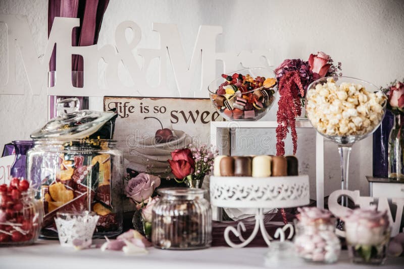 Candy Jars and Snacks with Wedding Decorations on the Table Stock Photo ...