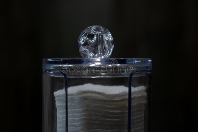 A Glass with a Cap for Cotton Pads on Black Background Stock Photo ...