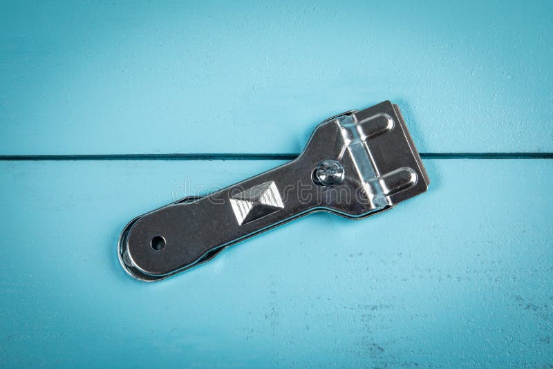 Glass Ceramic Scraper on a Blue Wooden Texture Background Stock Image ...