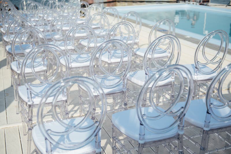 Glass Chairs Stand in a Row in a Beautiful Wedding Outing Ceremony ...