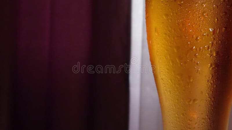 A Glass of Chilled Beer with Droplets Running Down it Stock Video ...