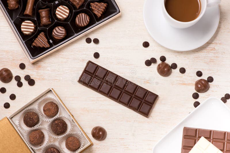 Glass of Chocolate Milk and Variety Chocolates on Table Stock Photo ...