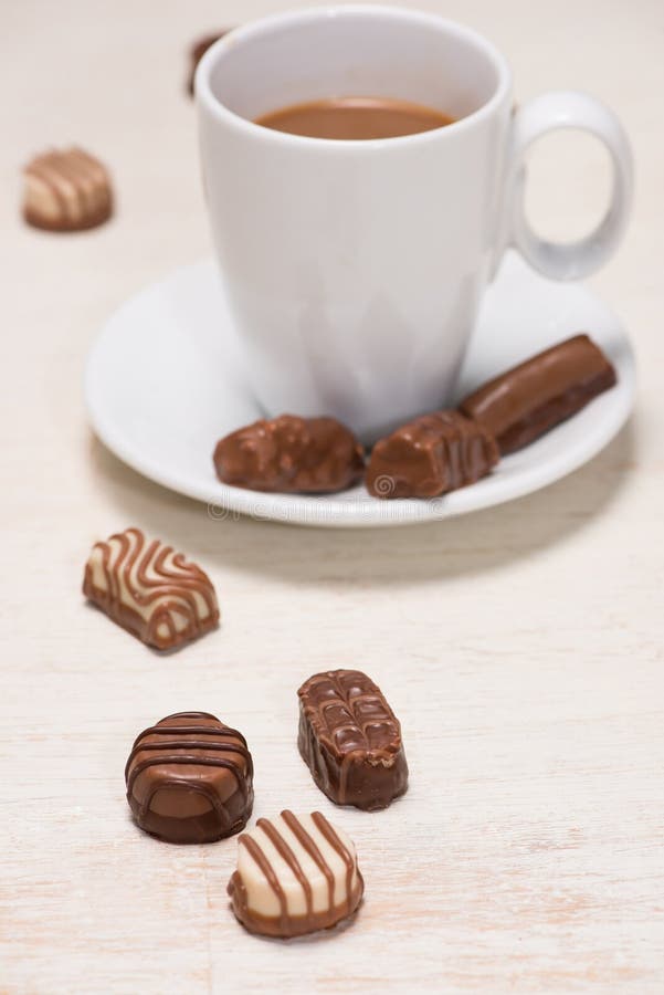 Glass of Chocolate Milk and Variety Chocolates on Table Stock Photo ...