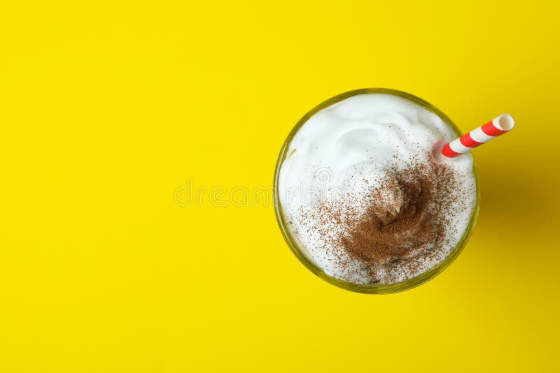 Glass of Chocolate Milkshake with Straw on Yellow Background Stock ...