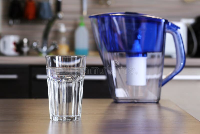 Glass of Clean Water and Filter for Cleaning Drinking Water on the ...