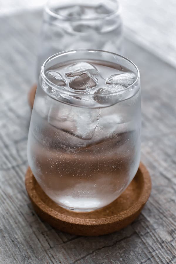 Glass of Clean Water and Ice Cubes on Wooden Table Stock Image - Image ...