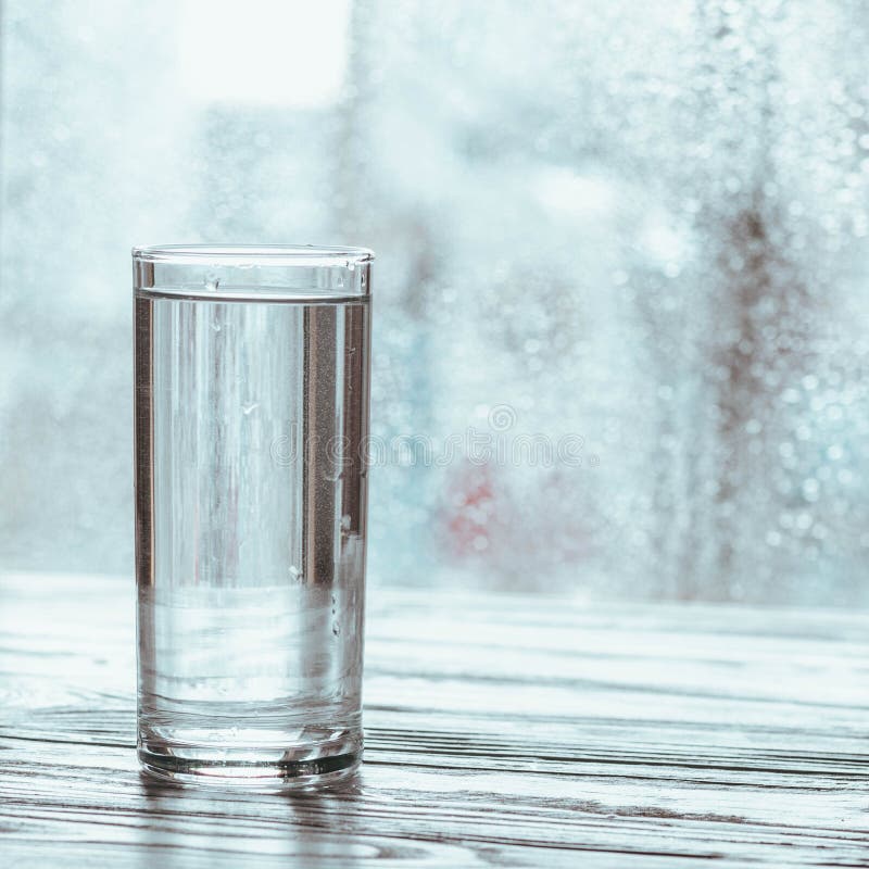 A Glass of Clear, Fresh, Clear Water is on the Table by the Window ...