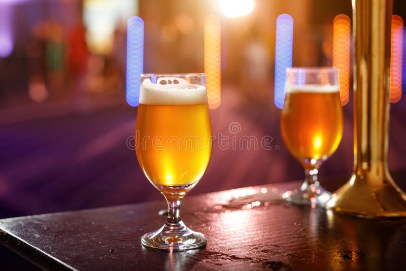 A Glass of Cold Beer on the Wooden Table in a Bar. Stock Photo - Image ...