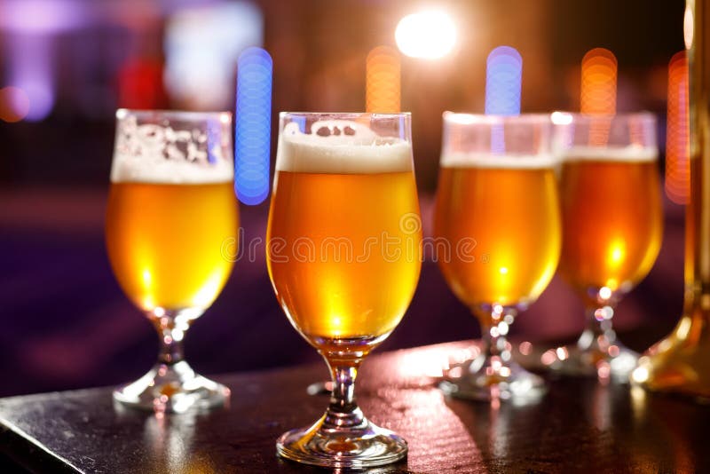 A Glass of Cold Beer on the Wooden Table in a Bar. Stock Photo - Image ...