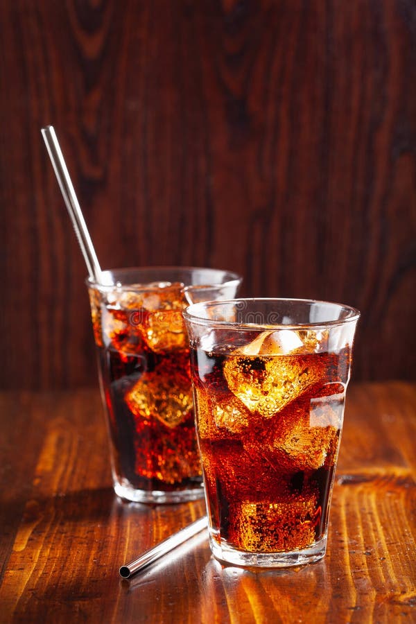 Glass of Cold Cola Soft Drink with Ice on Wooden Background Stock Photo ...