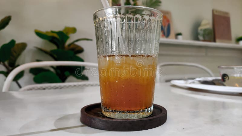 A Glass of Cold Iced Tea on a White Table Stock Image - Image of soda ...