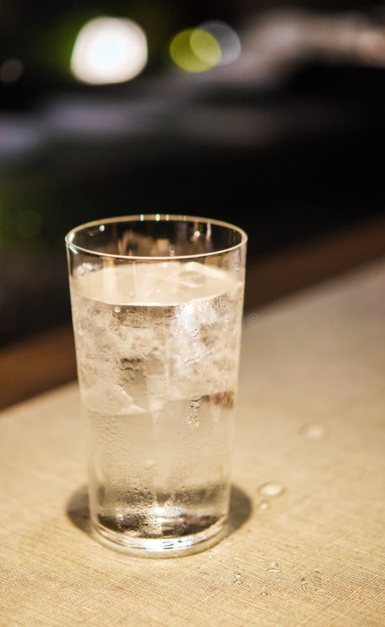 A Glass of Cold Water on a Table, Tokyo, Japan. Vertical. Stock Photo ...