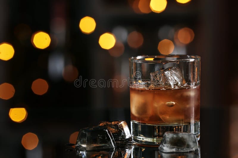 Glass of Cold Whiskey with Ice on Table in Bar Stock Photo - Image of ...