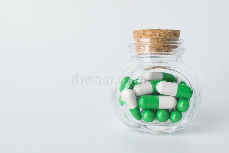Glass Container with Capsules on a White Background with a Copy Space ...
