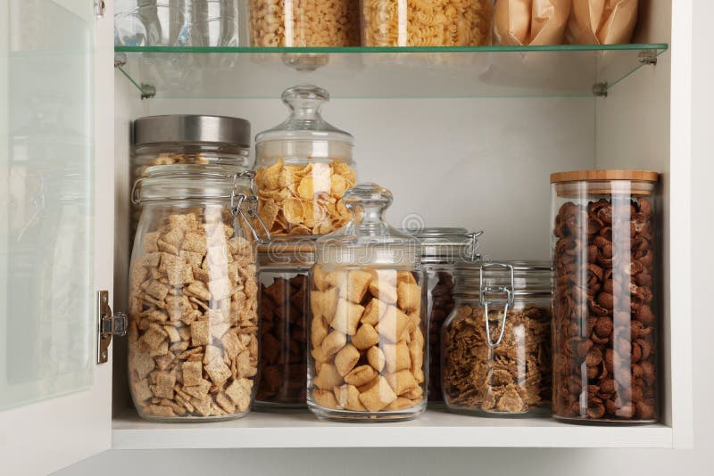 Glass Containers with Different Breakfast Cereals on Shelf Stock Image ...