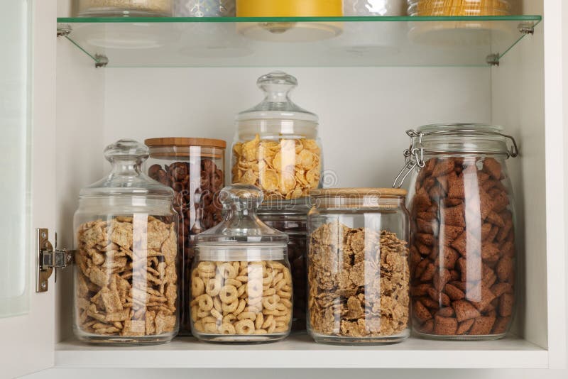 Glass Containers with Different Breakfast Cereals on Shelf Stock Image ...