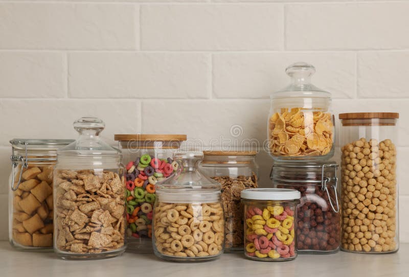 Glass Containers with Different Breakfast Cereals on White Countertop ...