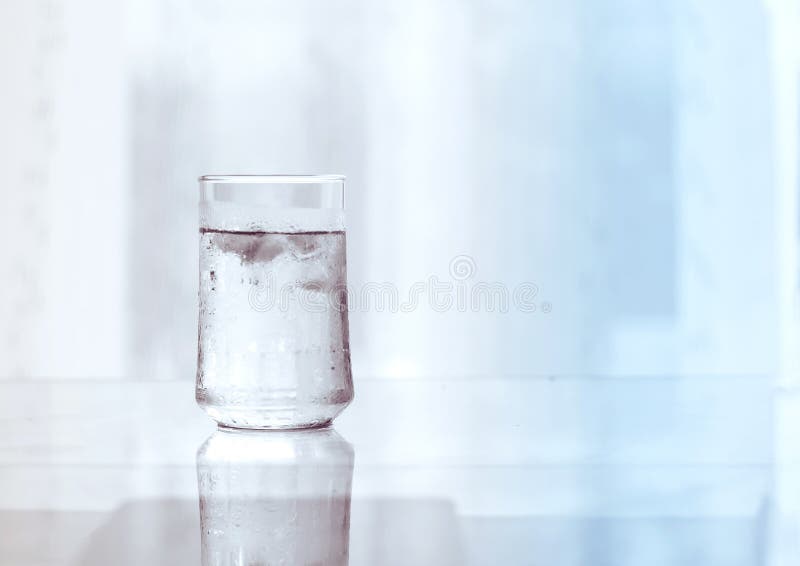 Glass of Cool Fresh Drink with Ice Cube on the Table Stock Image ...