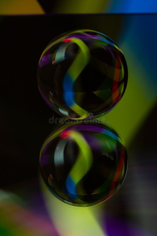 Glass Crystal Ball on a Mirror Surface with a Multicolor Pattern Light ...
