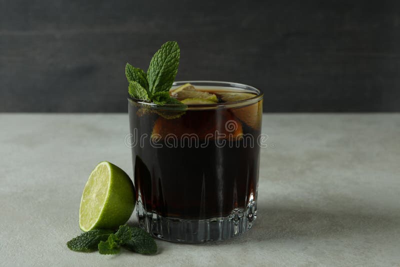 Glass of Cuba Libre on White Textured Table Stock Photo - Image of lime ...
