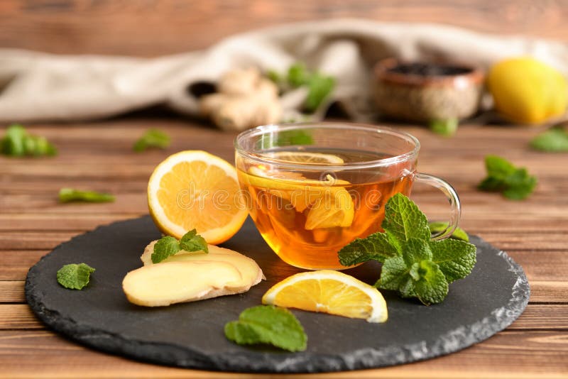 Glass Cup of Aromatic Tea with Lemon and Ginger on Slate Plate Stock ...