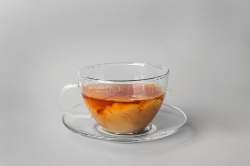 Glass Cup of Aromatic Tea with Milk on Light Background Stock Photo ...