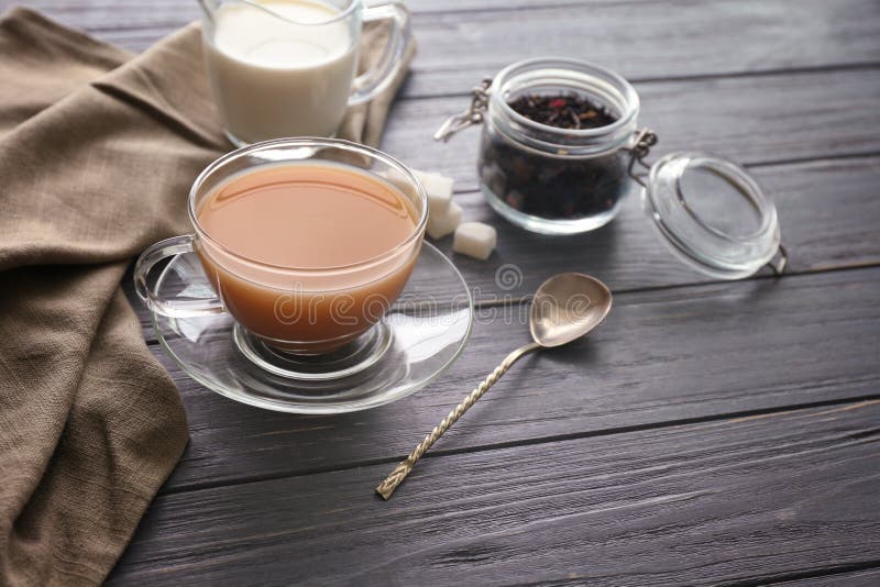 Glass Cup of Aromatic Tea with Milk on Wooden Table Stock Image - Image ...