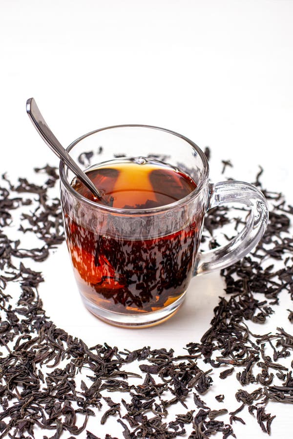 A Glass Cup with Black Natural Aromatic Tea and Large Tea Leaves Stock ...