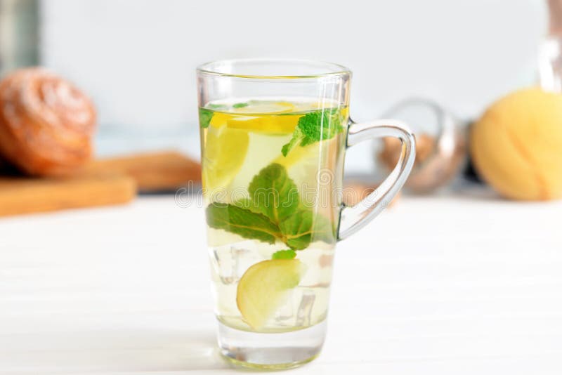Glass Cup of Cold Mint Tea with Lemon and Ginger on Table Stock Photo ...