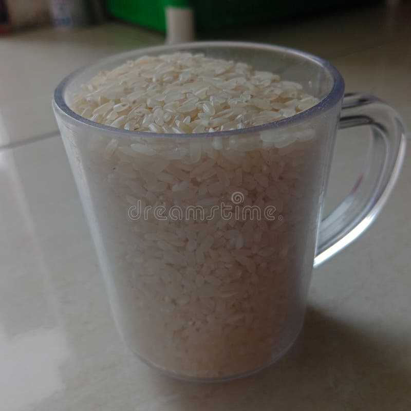 A Glass Cup Containing Rice Grains Stock Photo - Image of glass, grains ...