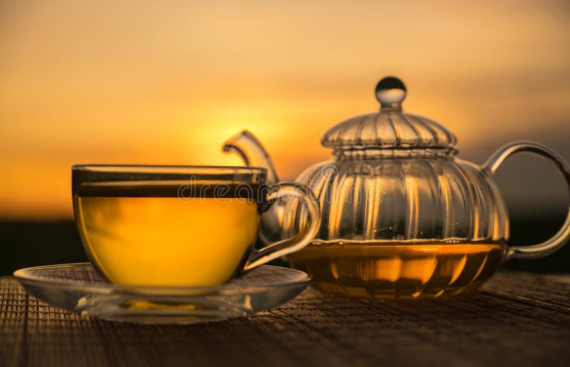 Glass Cup and Teapot Sunset Background Stock Image - Image of glass ...