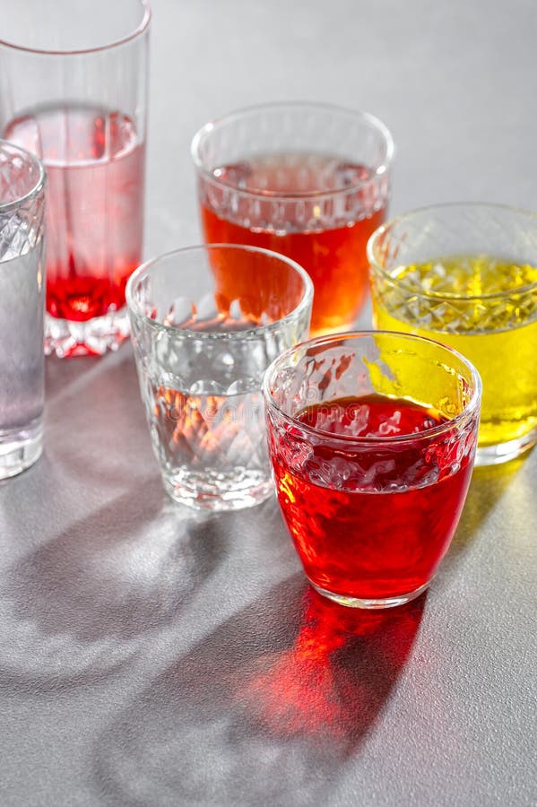 Glass Cups with Colorful Cold Drinks on a Gray Stone Table. Shooting ...