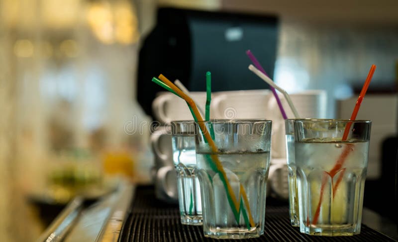 Glass Cups with Tubes Filled Water at the Bar Stock Photo - Image of ...