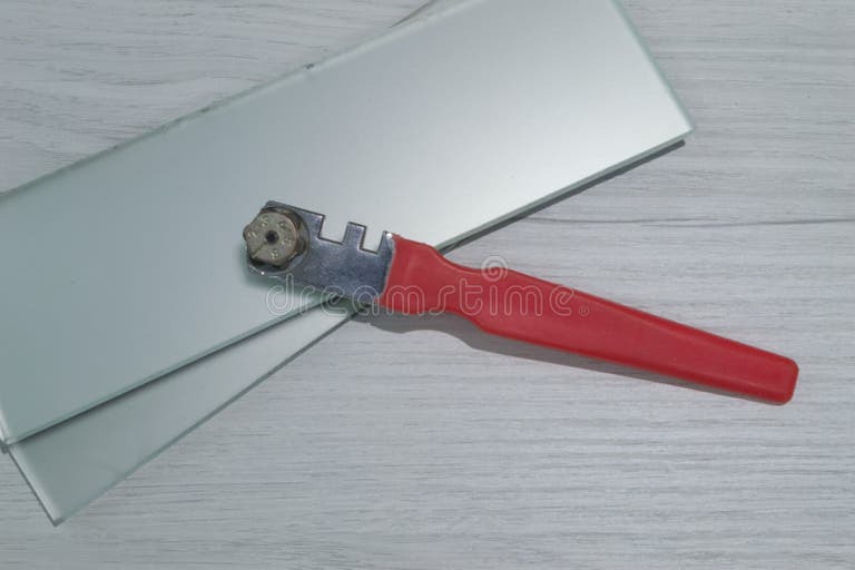 Glass Cutter with a Red Handle Rests on Mirrors Stock Image - Image of ...