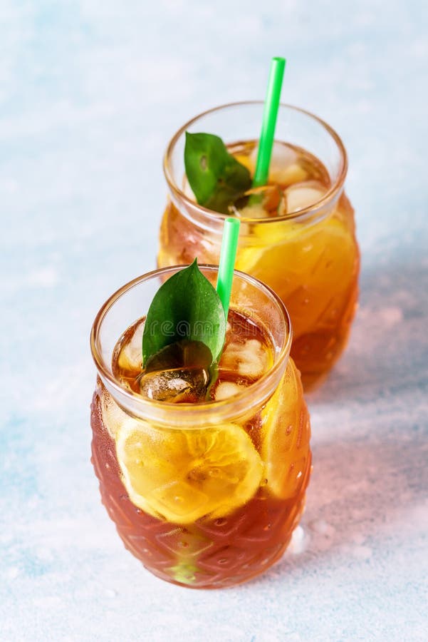 Glass of Delicious Iced Tea with Lemon on Light Blue Background Above ...