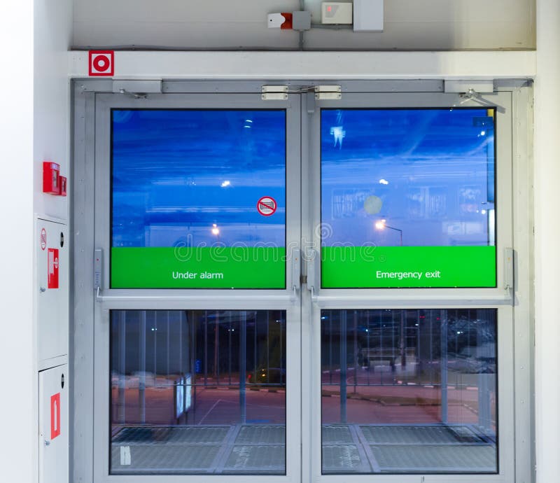 Glass Door Emergency Exit To a Street. Evening Time Stock Image - Image ...