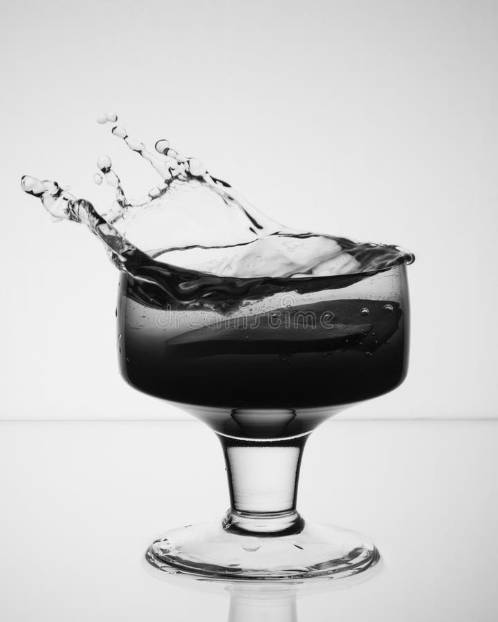 Glass with a Drink Splashing Out Stock Image - Image of crystal, drink ...