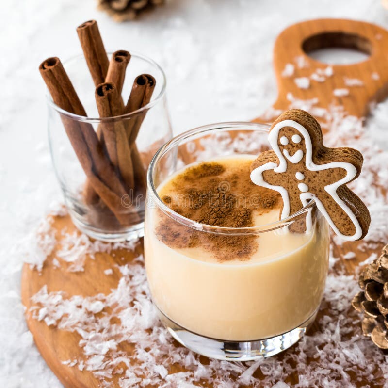 A Glass of Egg Nog Garnished with Cinnamon and a Gingerbread Man Cookie ...
