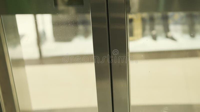 Glass Elevator Moving Down Inside Shopping Mall. View through Glass ...